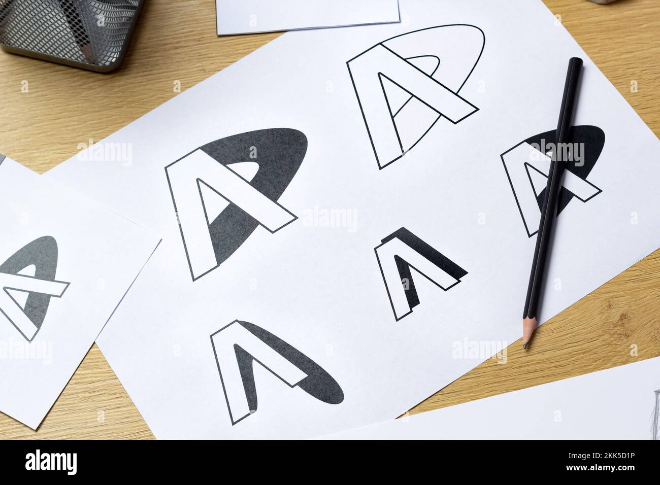 A graphic designer develops a logo for a brand. The illustrator draws ...