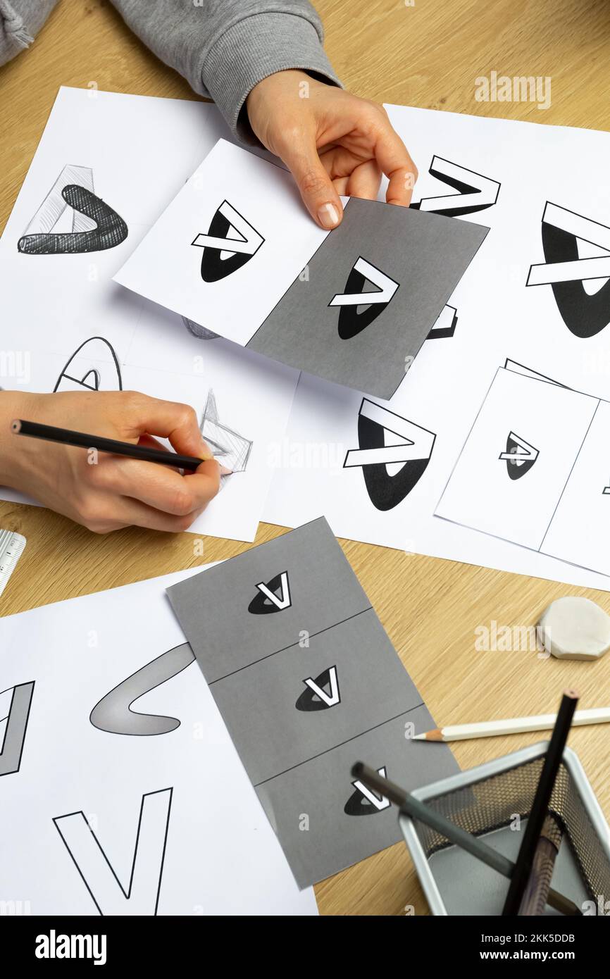 A graphic designer develops a logo for a brand. The illustrator draws ...