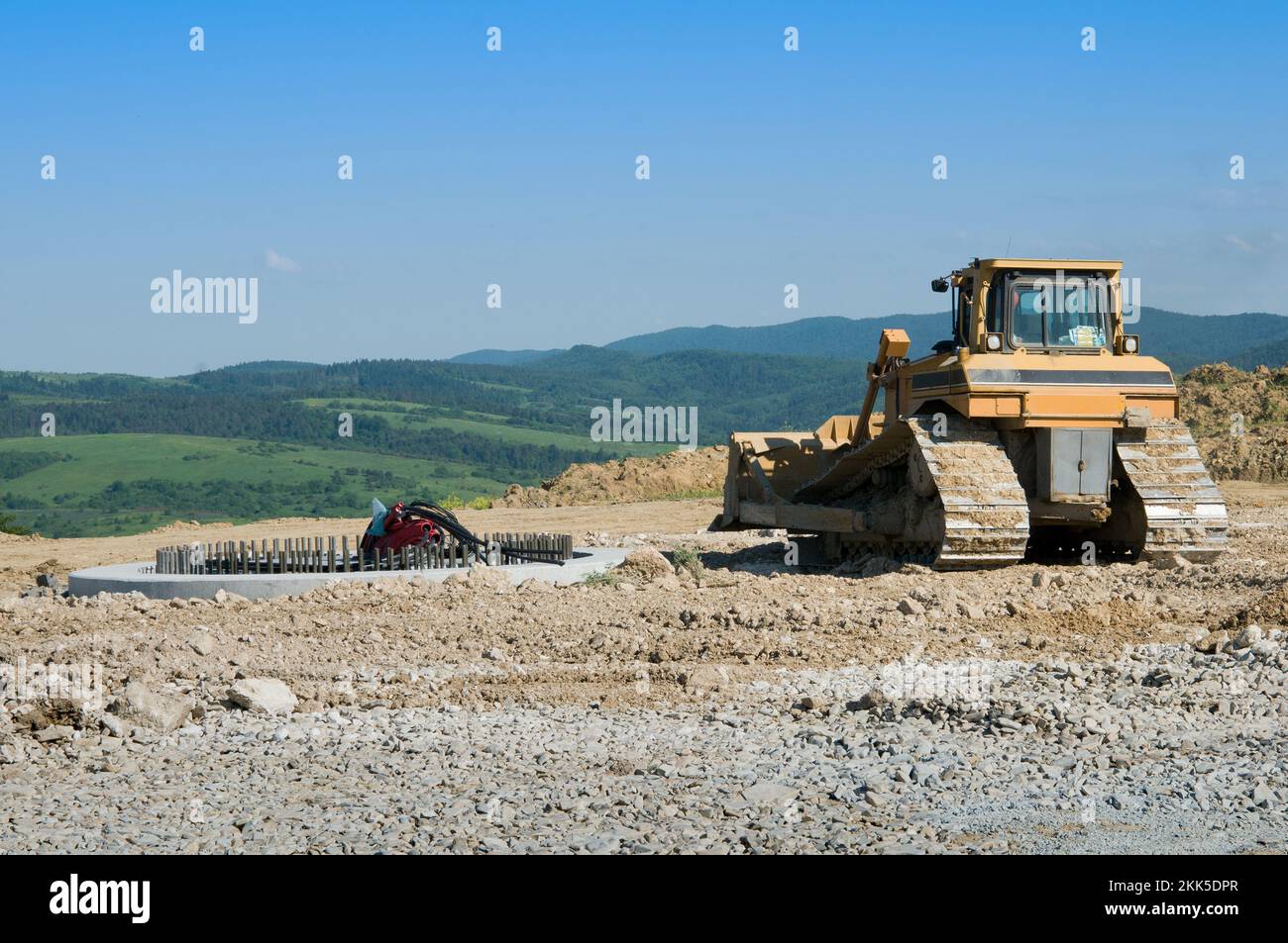 Wind power plant construction and yellow bulldozer Stock Photo - Alamy