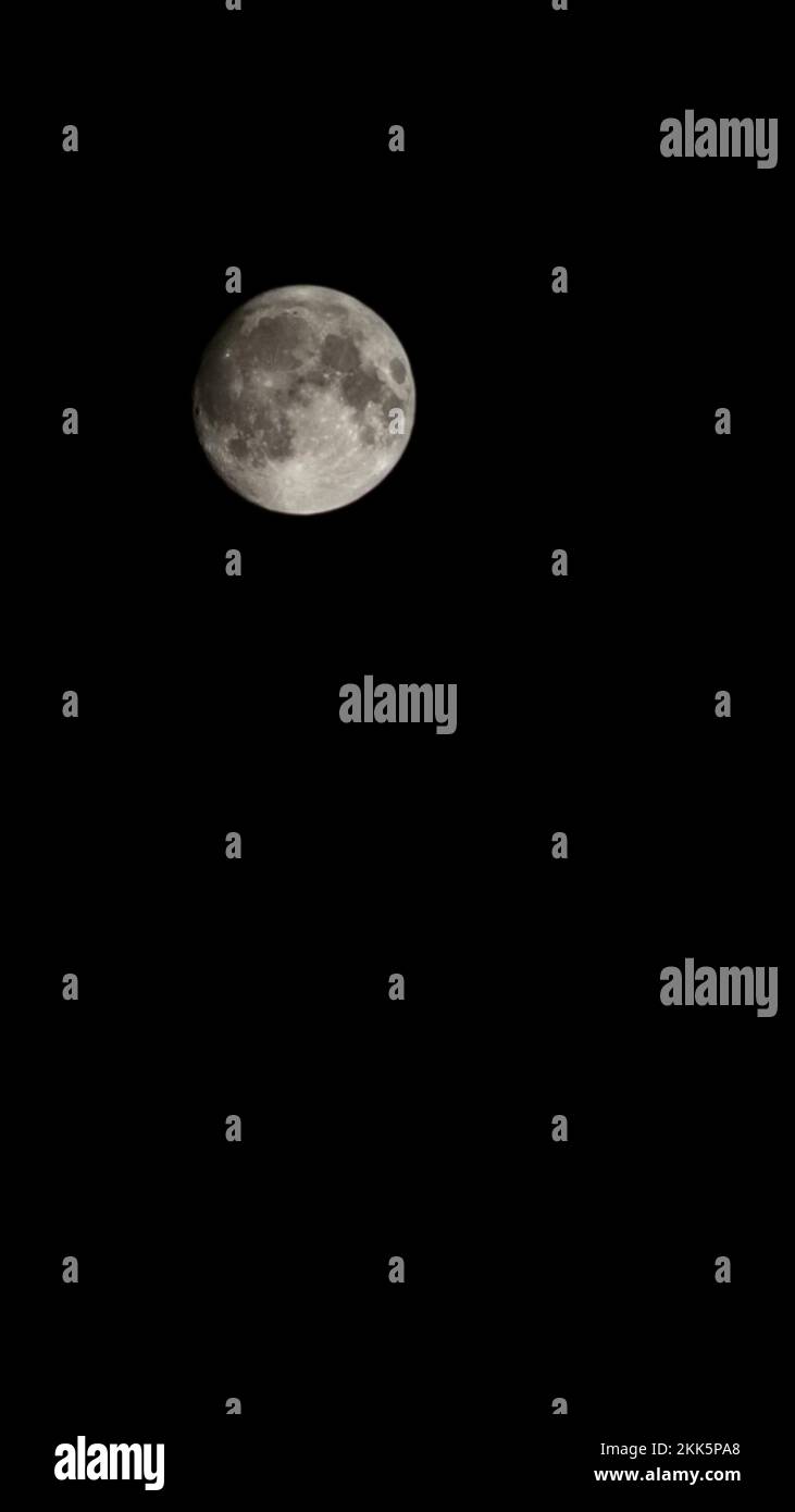 A scenic zoomed-in shot of the moon in the night sky Stock Photo - Alamy