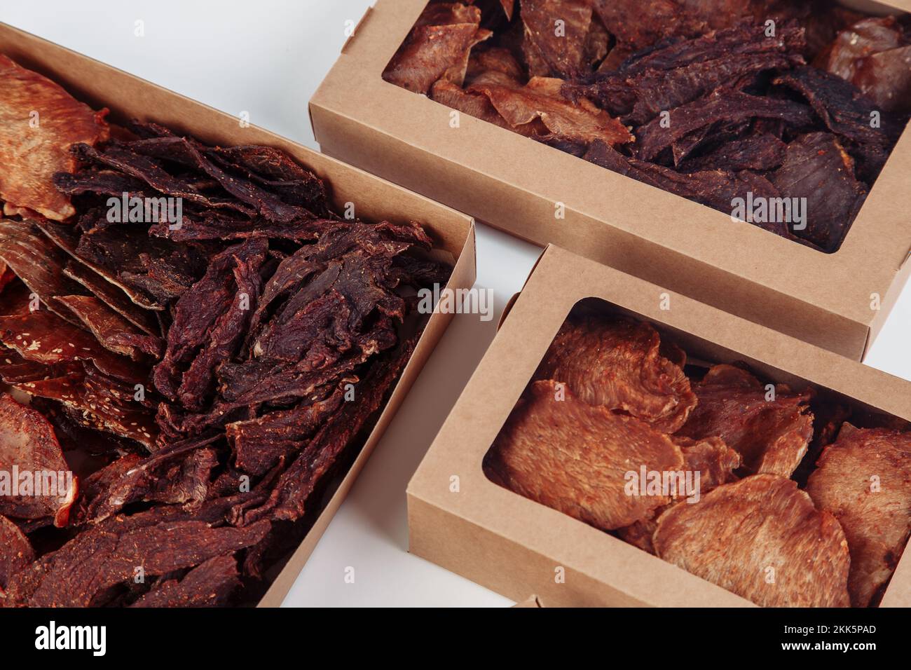 grilled and raw beef steak fillet meat with knife on wooden board ...