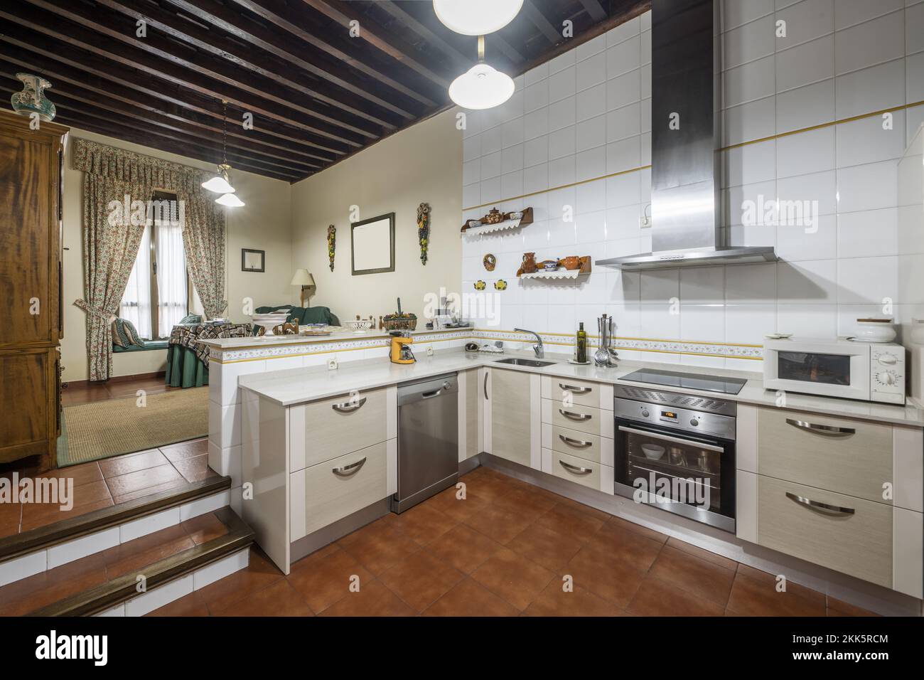Open kitchen with two-tone wooden base units, wooden coffered ceilings ...