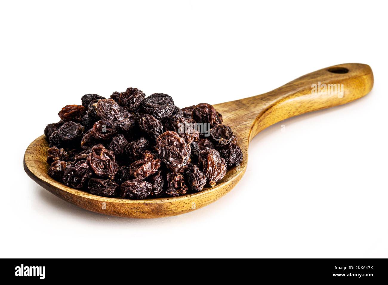 dried dried raisin made in brazil in rustic wooden spoon, isolated ...