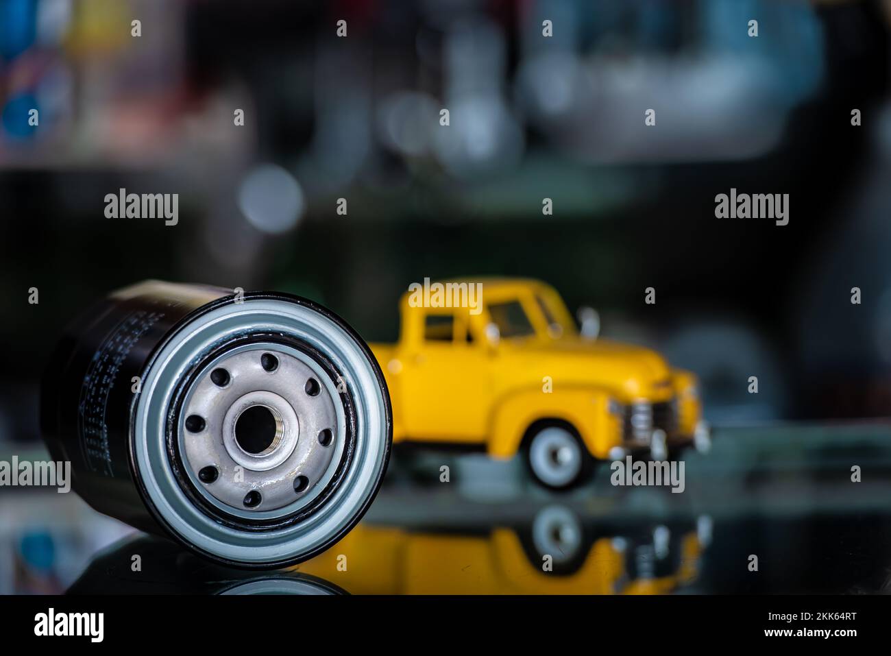 Engine oil lubricant filter with yellow truck car background in the ...