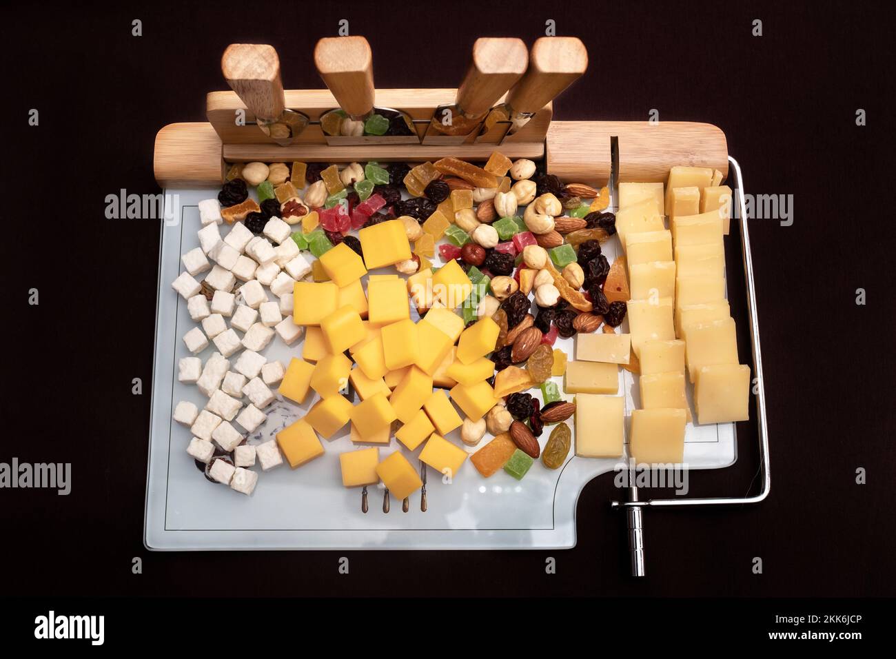 Cheese dish with various cheeses and dried fruits on a sliced Board ...