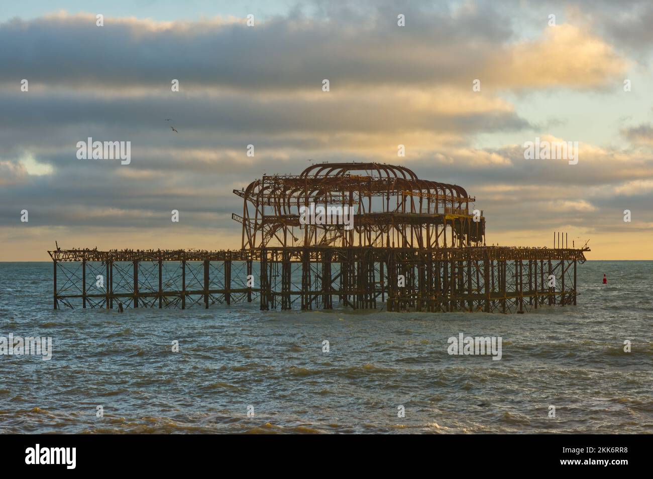 Ruined West Pier at Brighton in East Sussex, England. Evening sunset ...