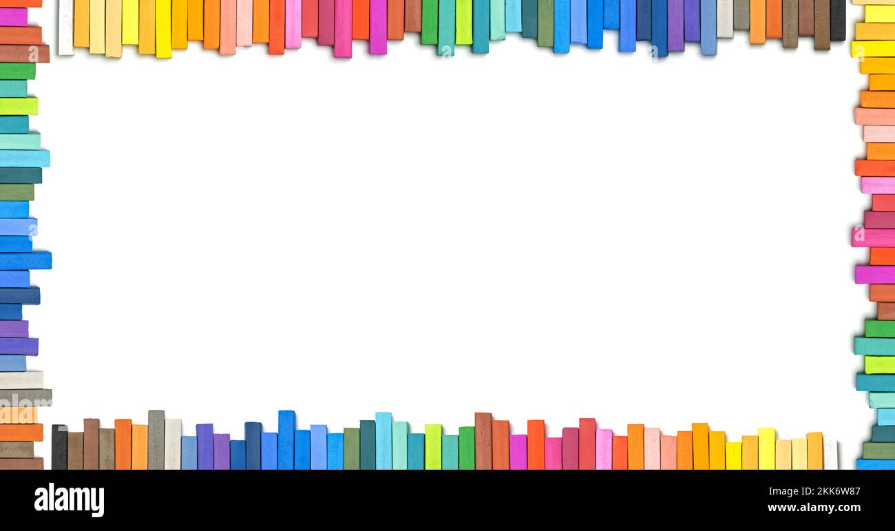 a frame made of Colorful chalk pastels, on white background, arranged ...