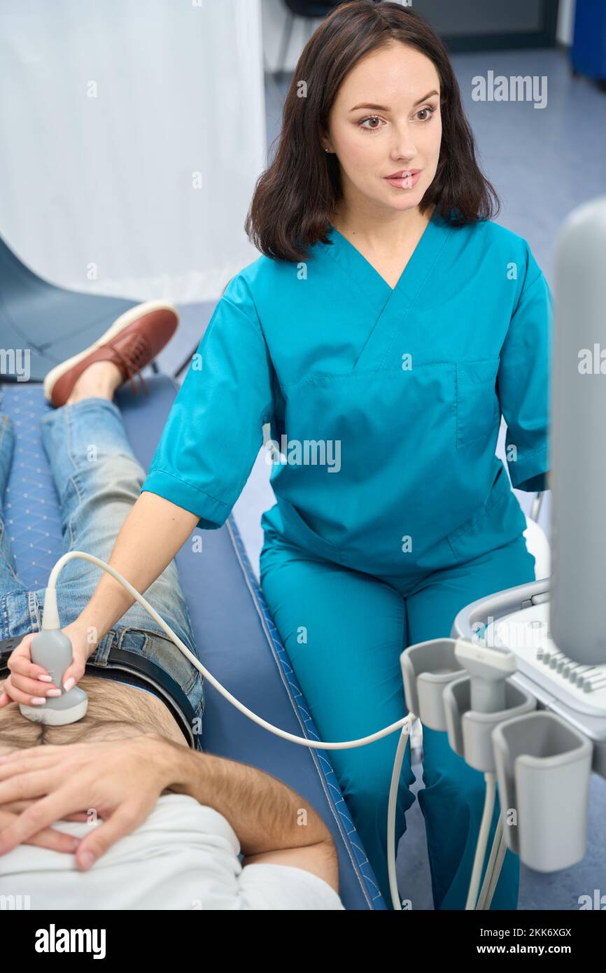 Woman examines image of internal organs of patient on monitor Stock ...