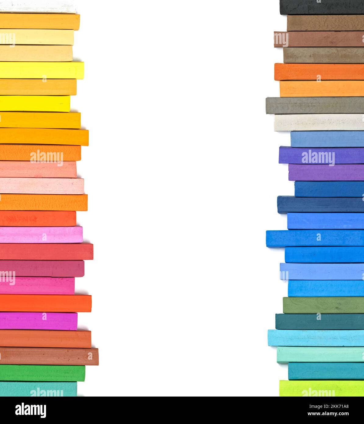 Hard chalk pastels arranged as rainbow spectrum on white background ...