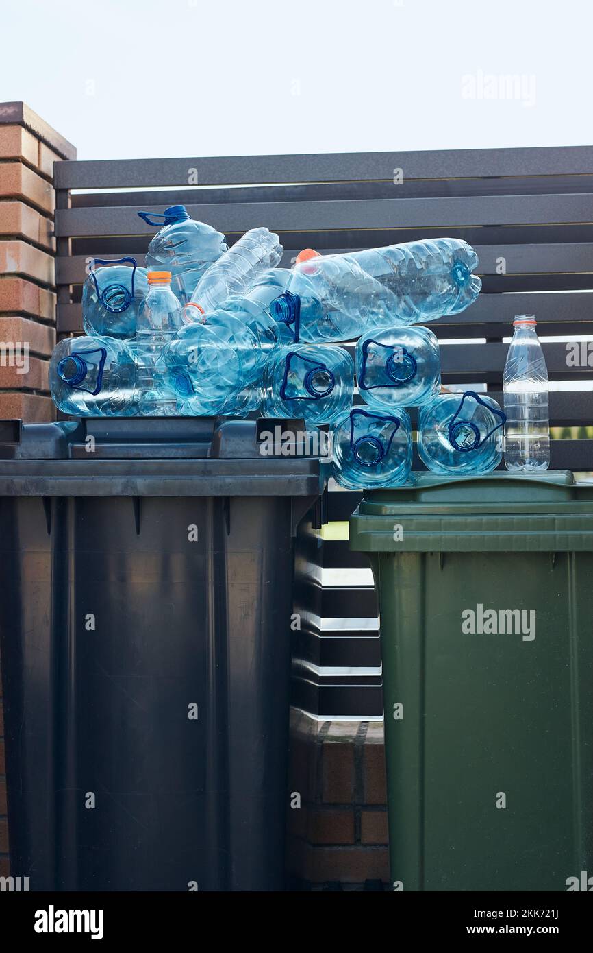 Disposal containers with empty used plastic water bottles on the top ...