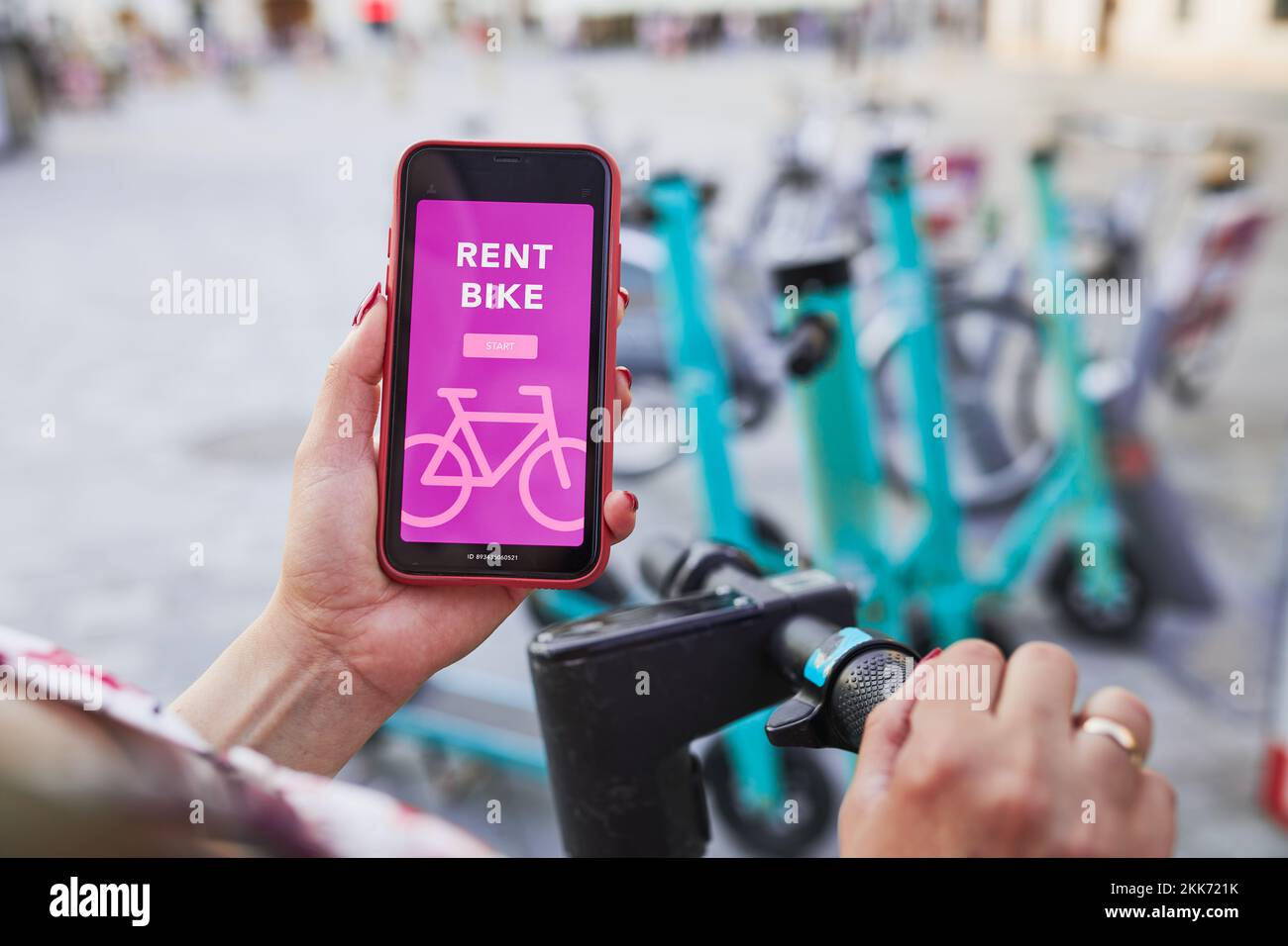 Renting bike using rental app on smartphone. Using bike sharing city ...