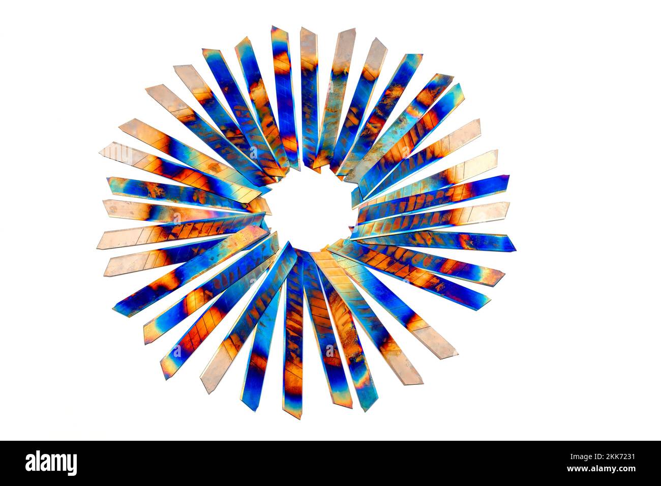 knife blades heated in the fire arranged in the form of sun rays on ...