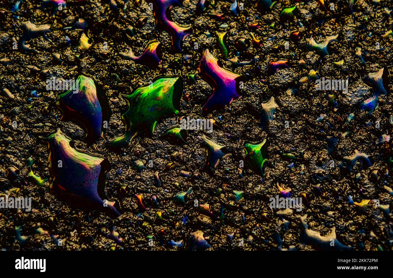 Oil stain on Asphalt road after rain, color Gasoline fuel spots on ...