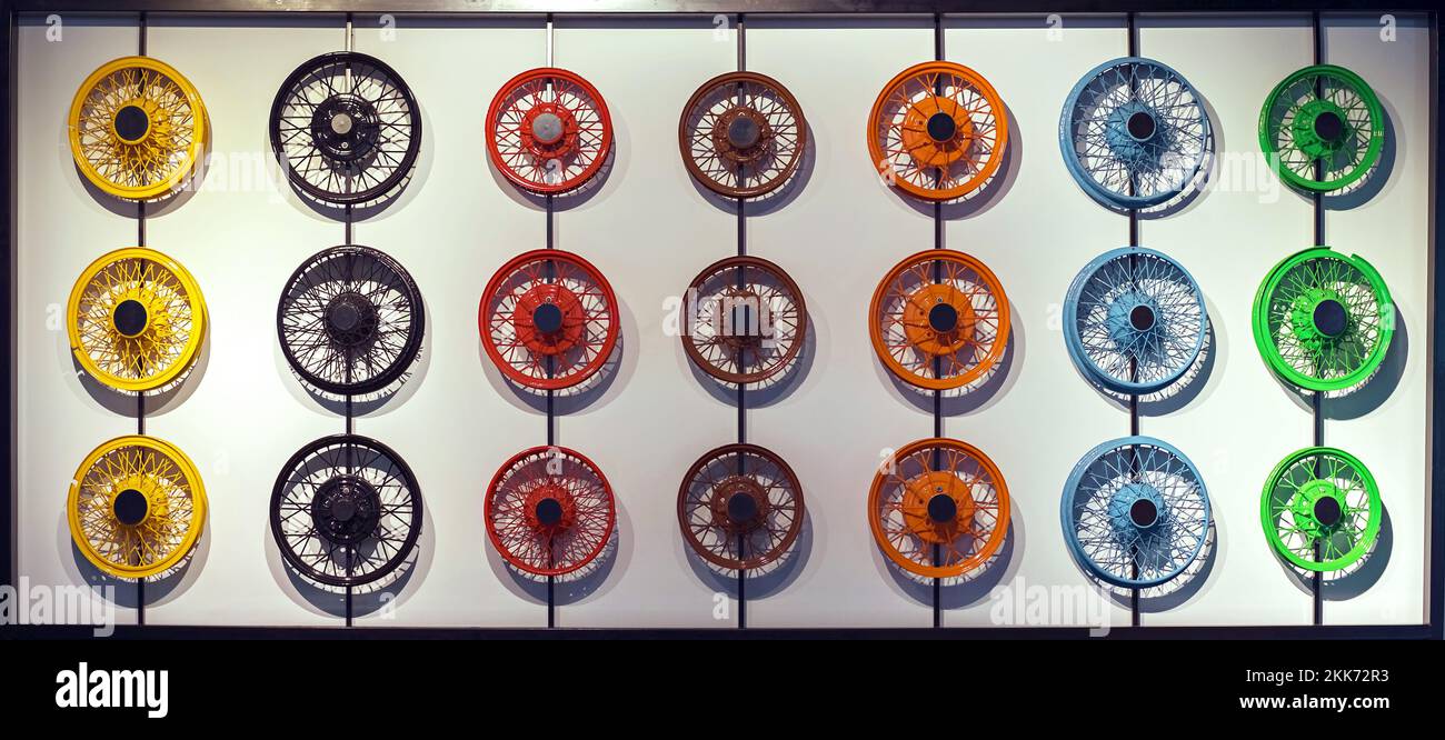 multicolored car wheels mounted on wall bracket Stock Photo - Alamy