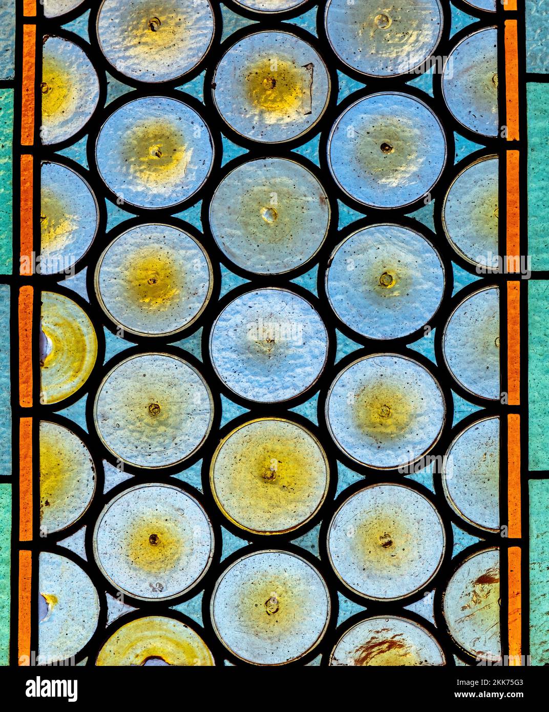 Traditional French chateau window made of circular tinted glass forming ...