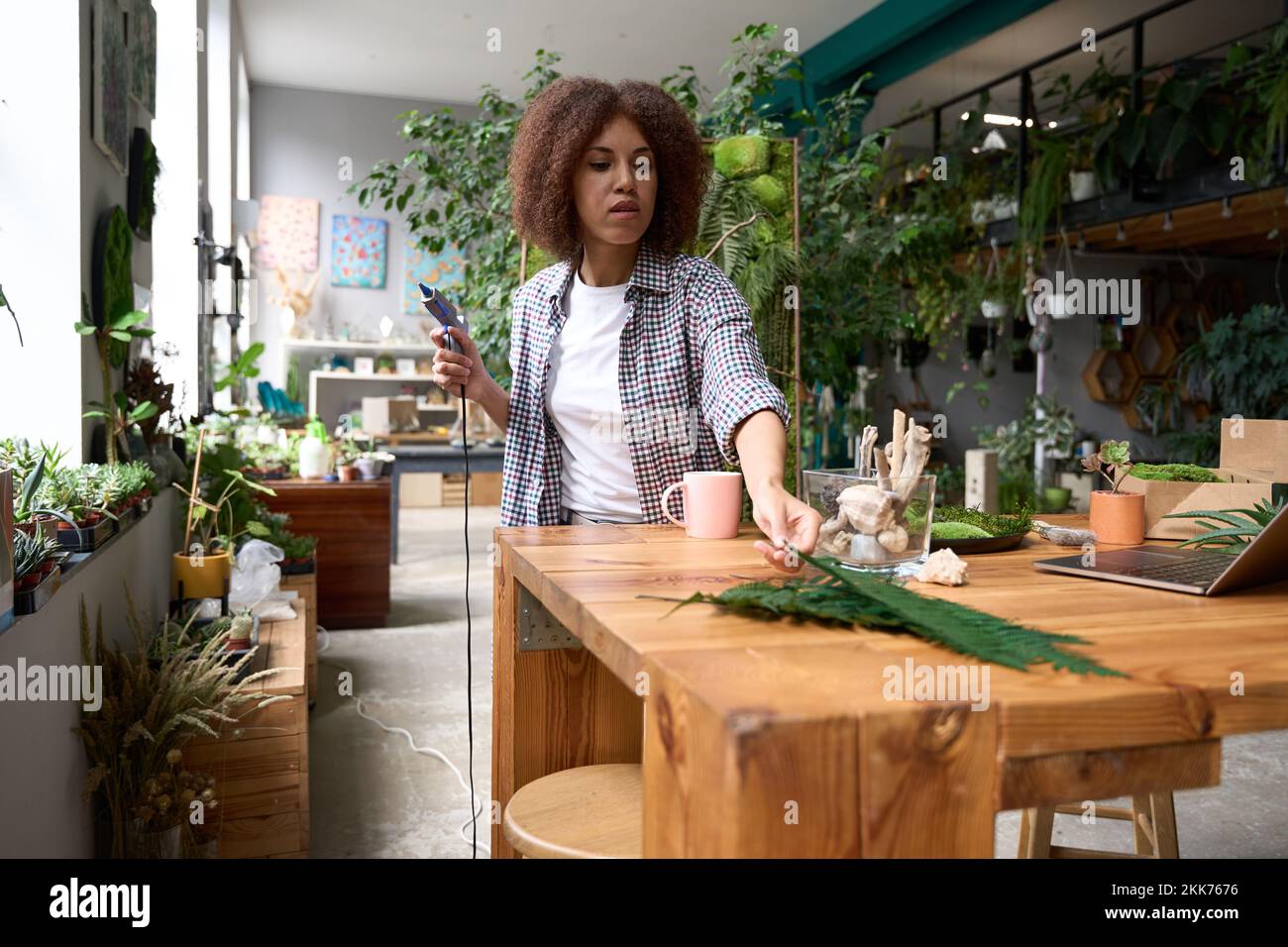 Female florist working with ikebanas in office Stock Photo - Alamy