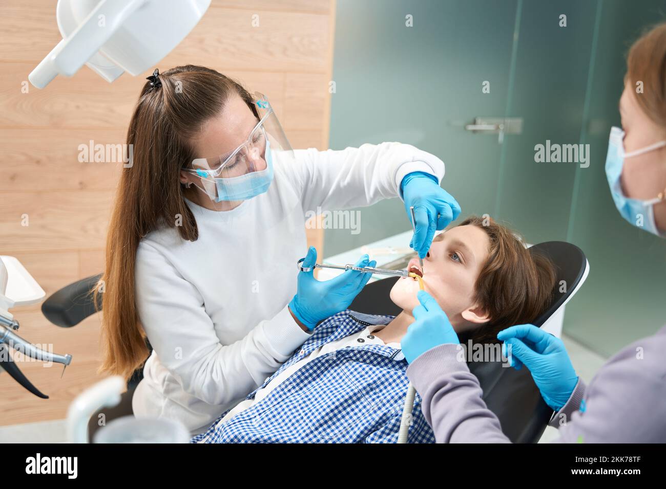 Boy is given an injection of anesthesia in dental office Stock Photo ...