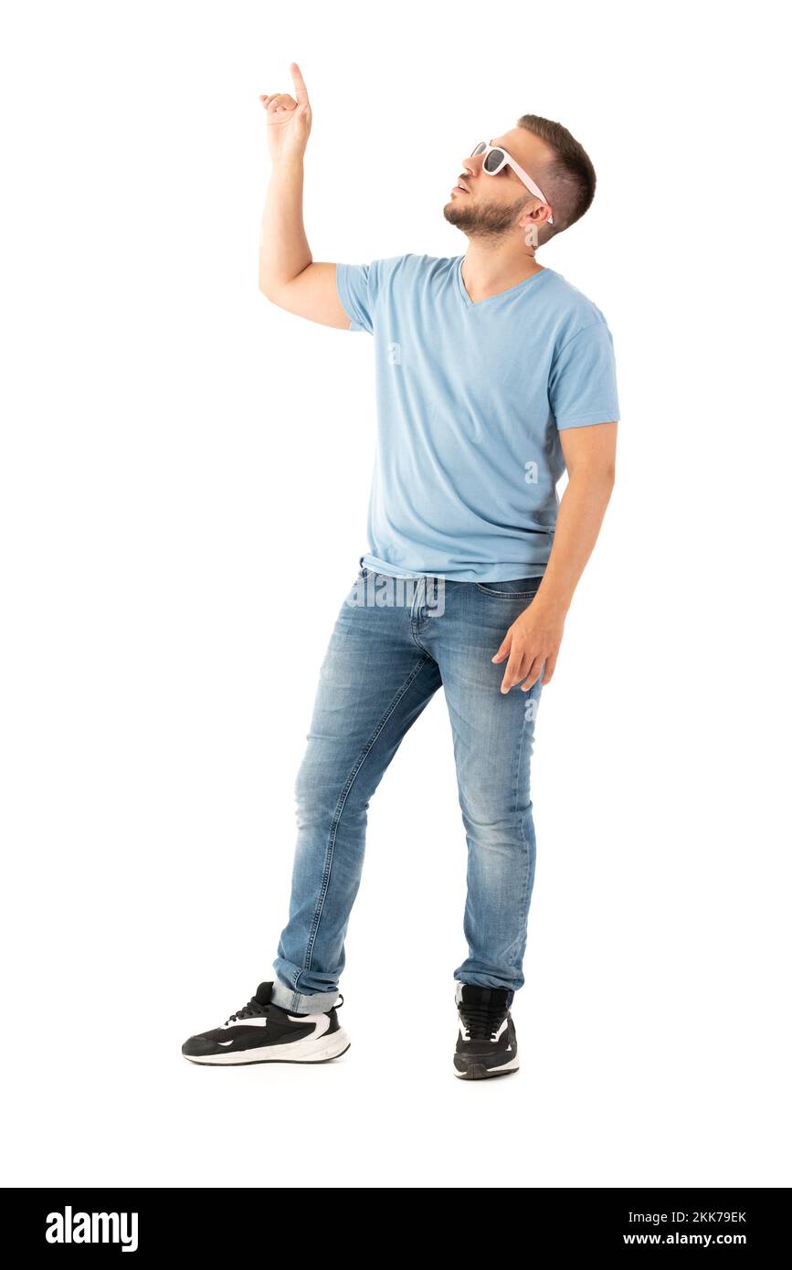 Young man raising his hand up to touch something on a white background ...