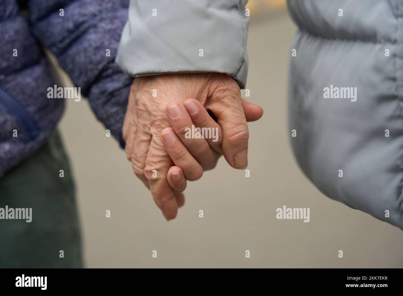 Child and grandmother hold hands while walking Stock Photo - Alamy