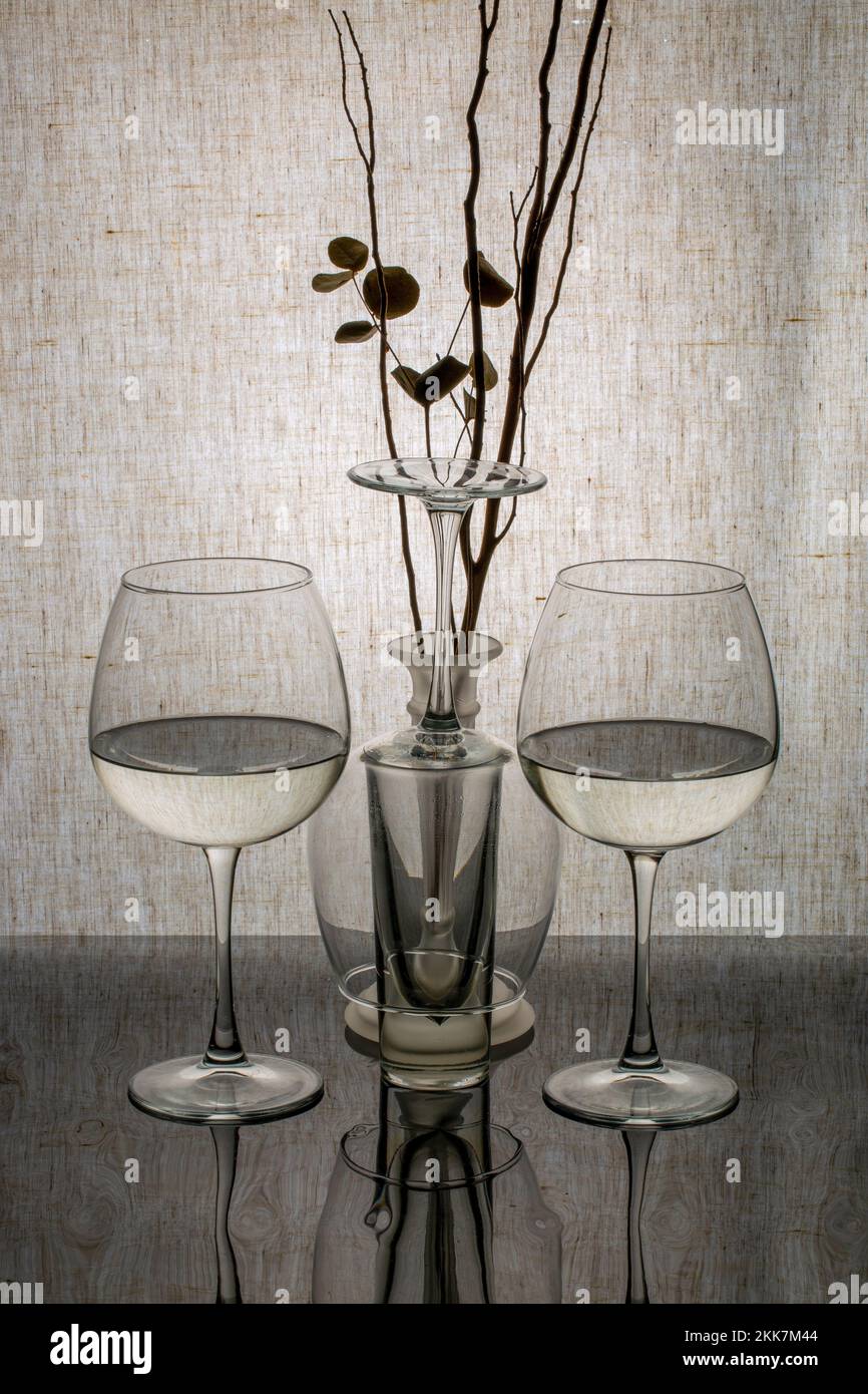 Still life with glass objects and a branch Stock Photo - Alamy