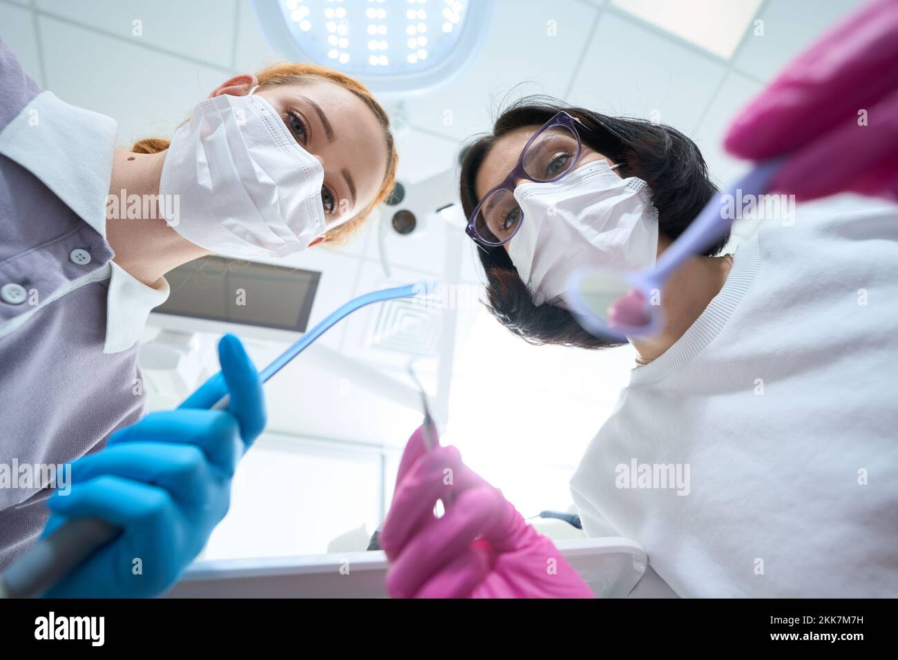 Two women in protective masks in process of dental manipulation Stock ...