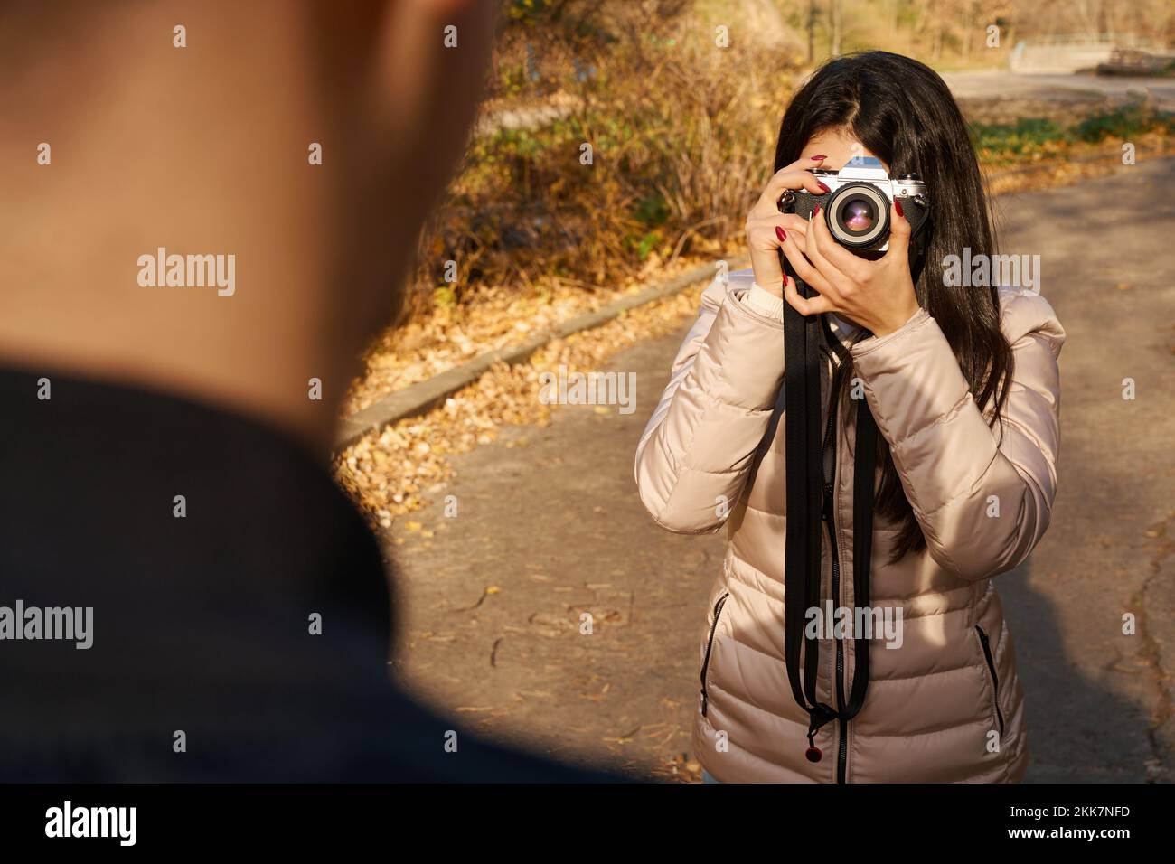 Long-haired woman holds a camera to her face Stock Photo - Alamy