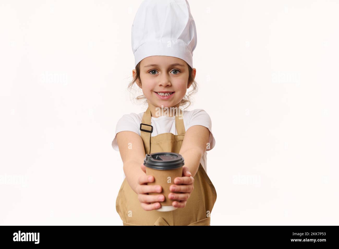 Caucasian little child girl dressed as barista, bartender in white chef ...