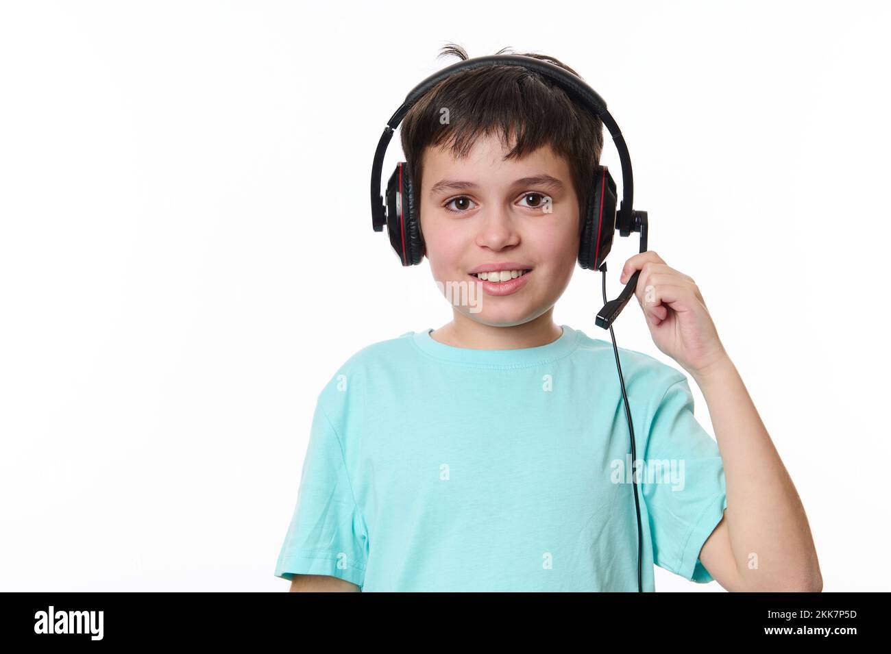 Handsome child boy in audio headset during a video class, smiling to ...