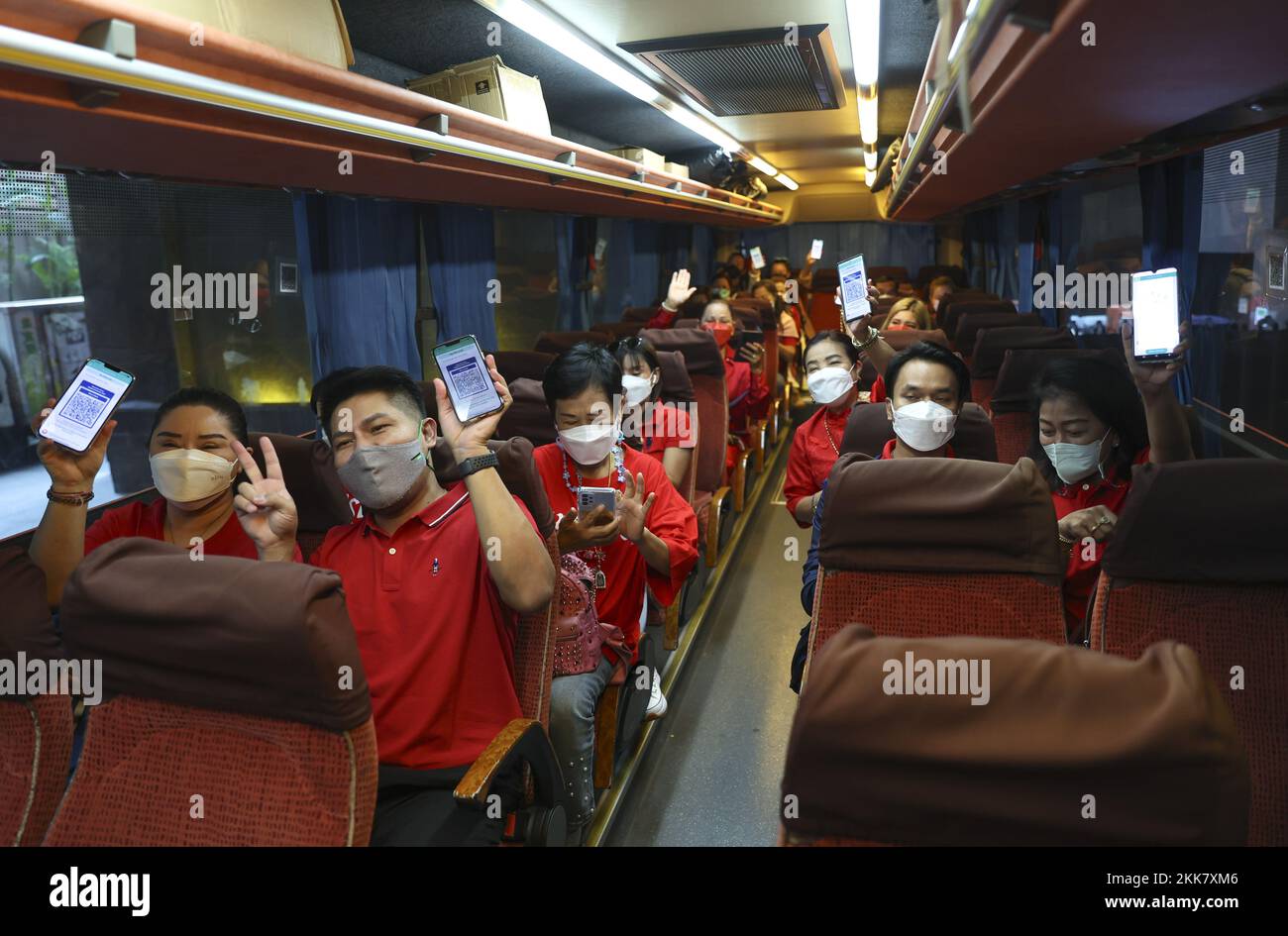 Members of a tour group from Thailand show off their blue codes which they got on the last day ...