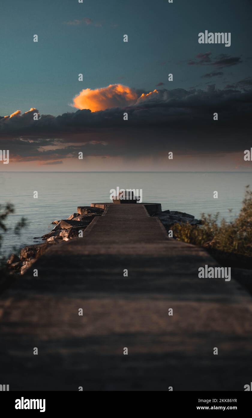 A beautiful view of an asphalt pathway to the Lake Erie on a sunset sky ...