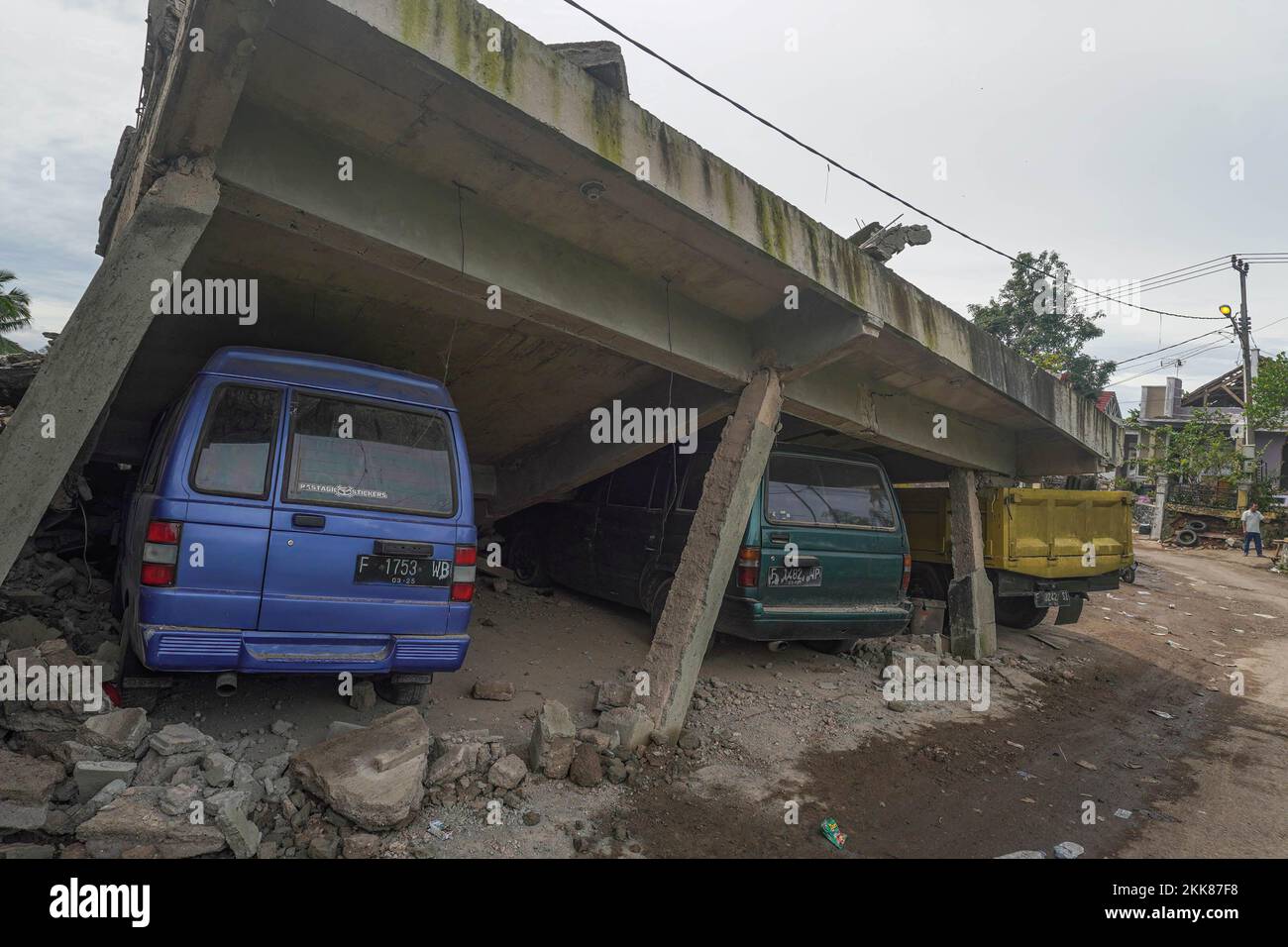 Vehicles seen under a collapsed structure during the aftermath of the ...