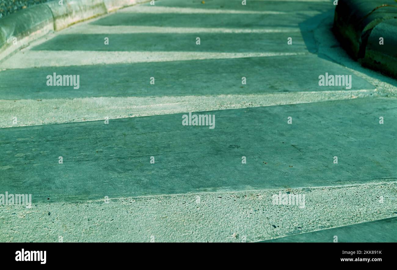 Dark mint and teal colored empty striped curving concrete path Stock ...