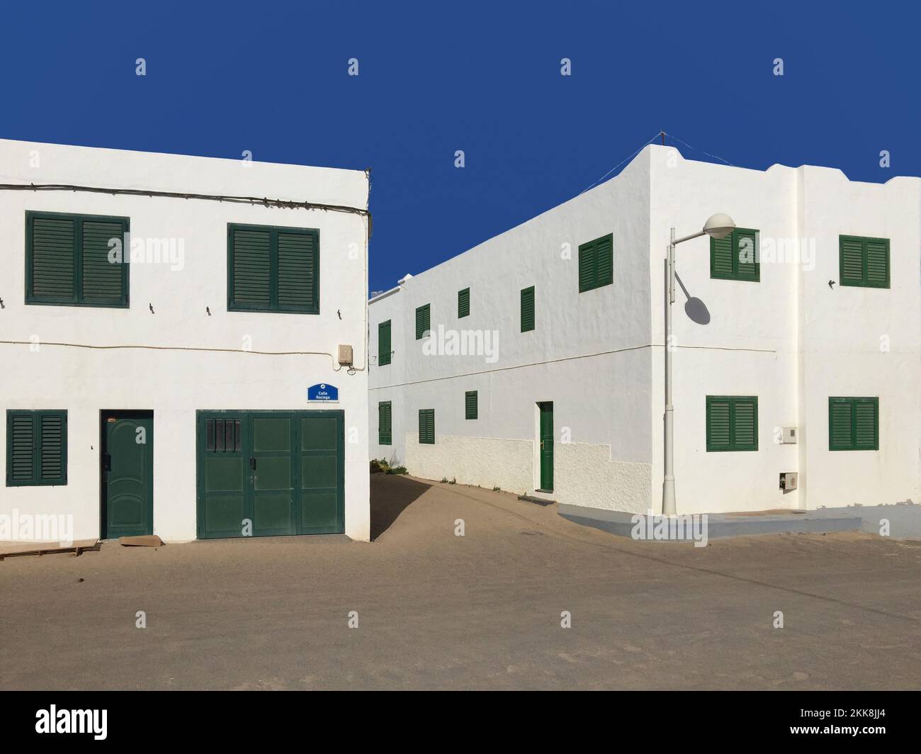 typical small road with white colored house walls in Famara, Lanzarote ...