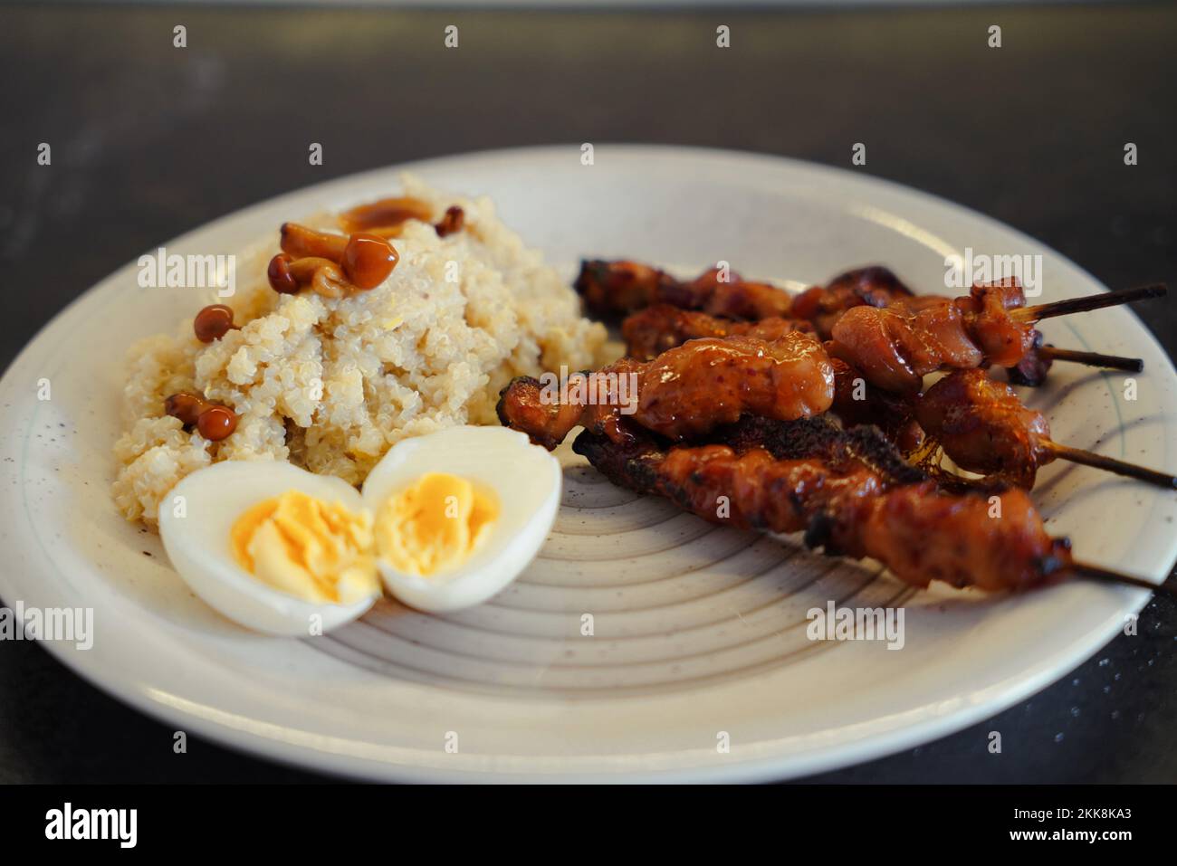 Japanese chicken skewers with quinoa, egg and wild mushrooms Stock ...
