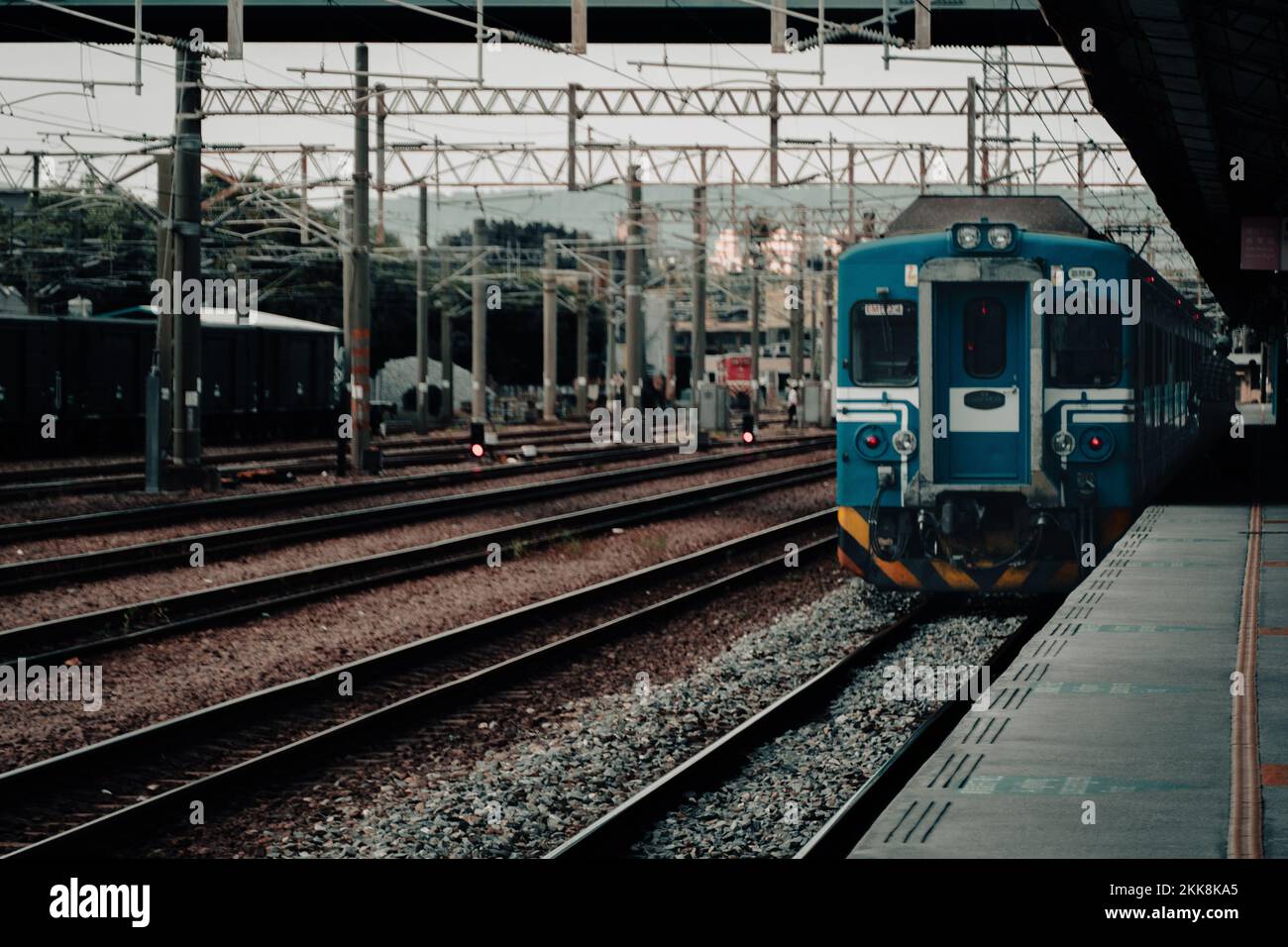 A departing train on railways in an empty station Stock Photo - Alamy