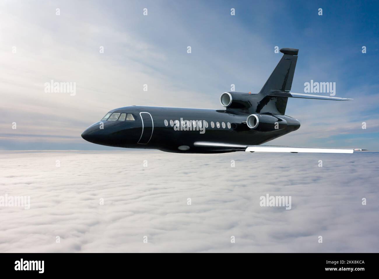 Black modern luxury executive aircraft flies in the air above the ...