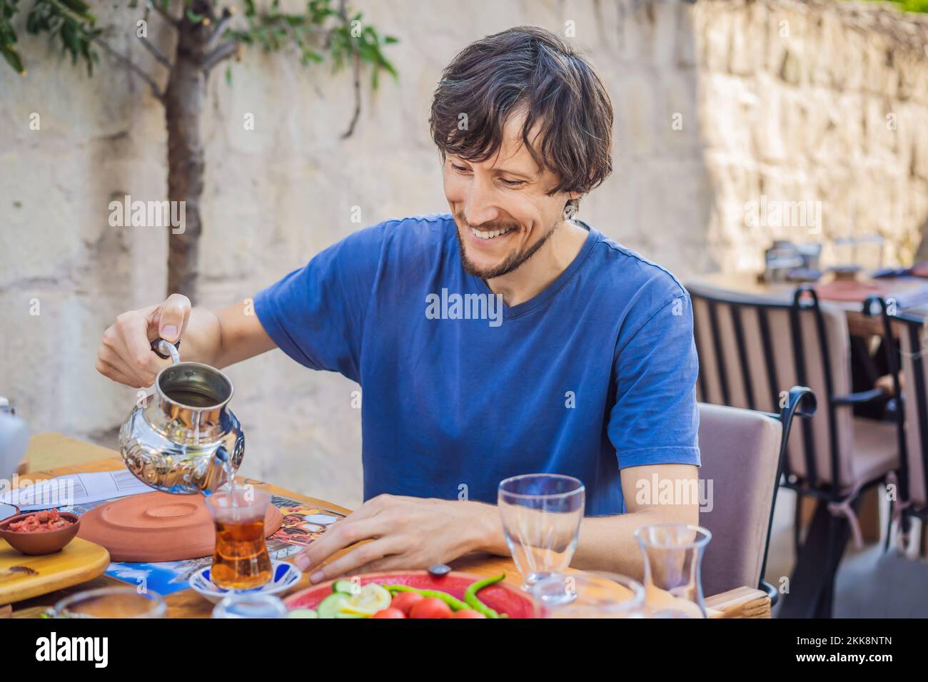 Man eating turkish breakfast. Turkish breakfast table. Pastries ...