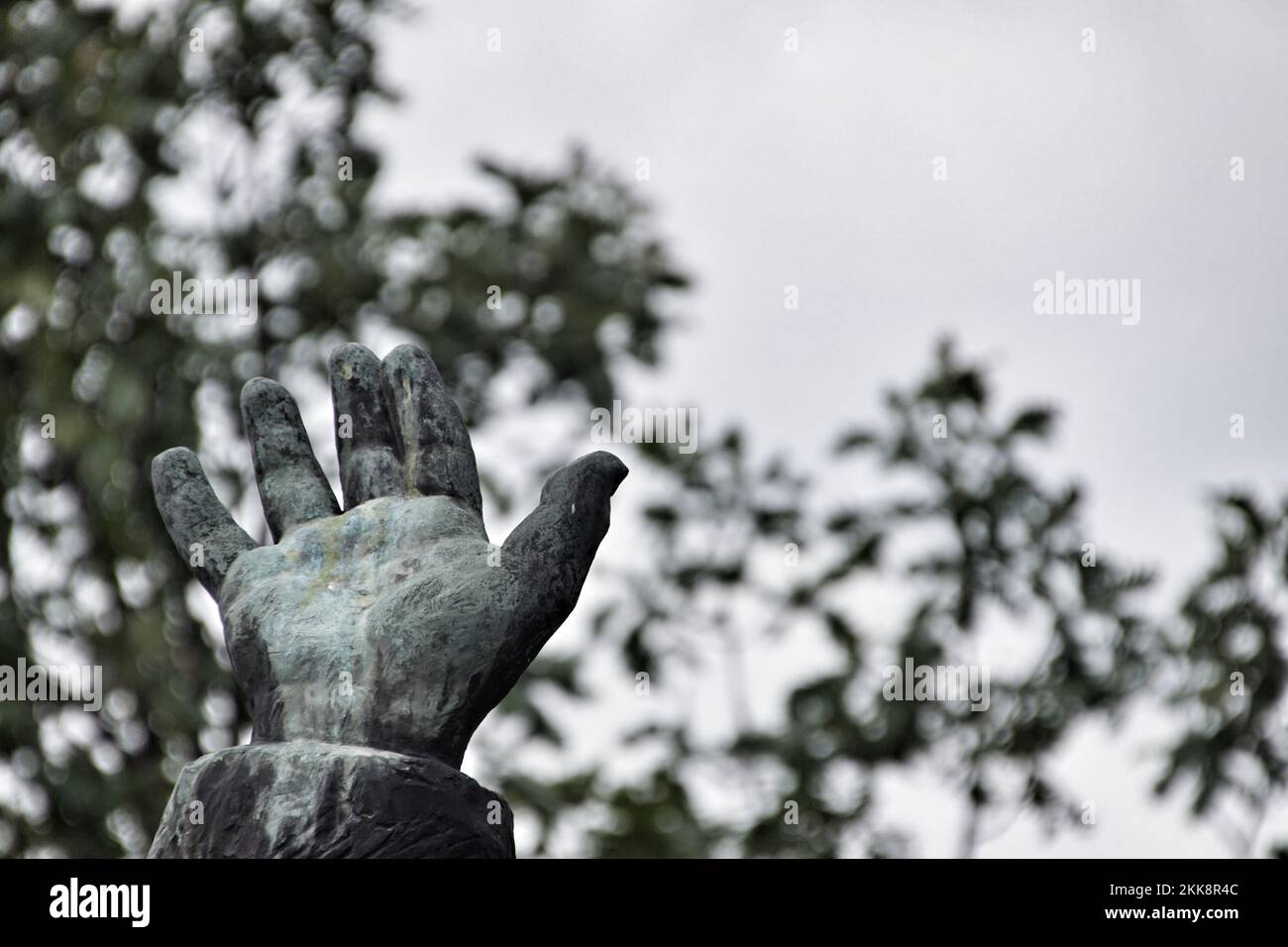Low angle view of statues hand against sky Stock Photo - Alamy