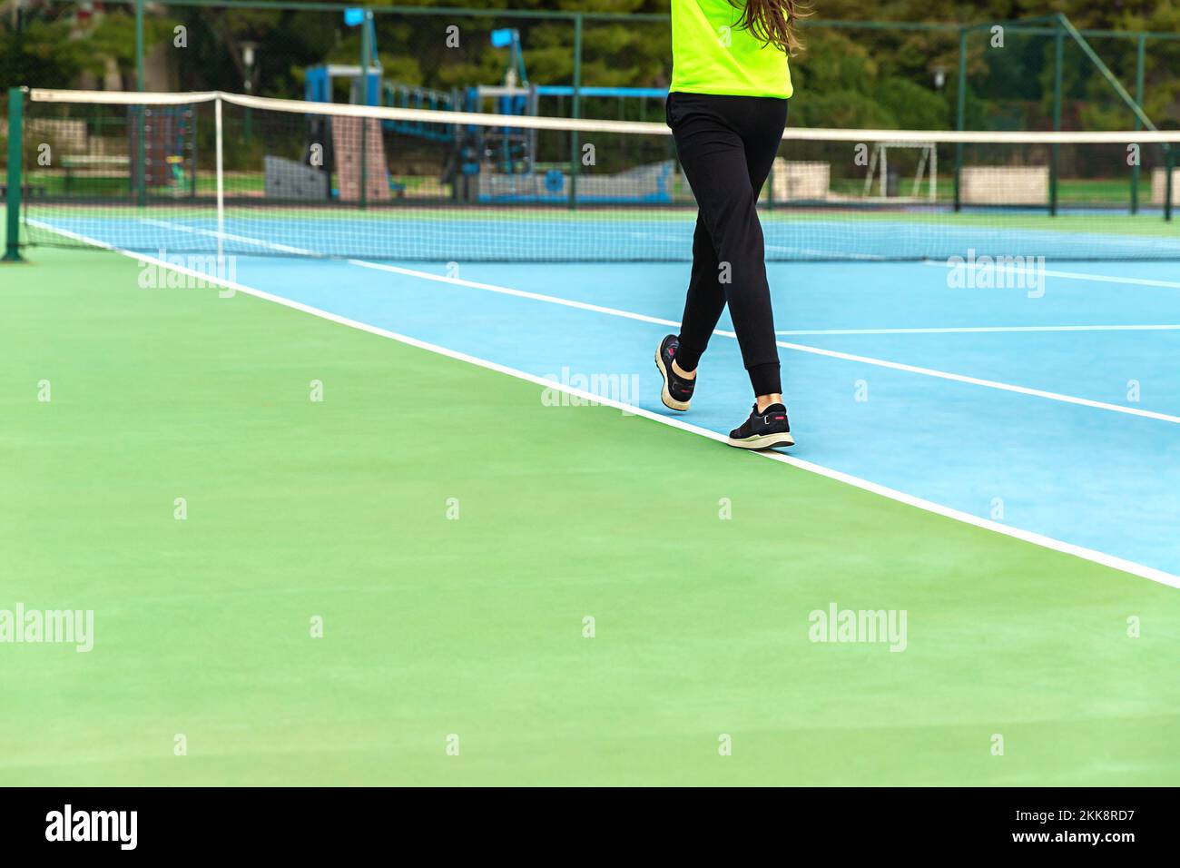 Legs of the young girl on tennis court. Walking the tennis court. Sport ...