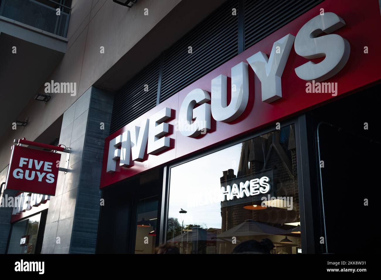 The logo of the fast food company Five Guys is seen on top of a ...