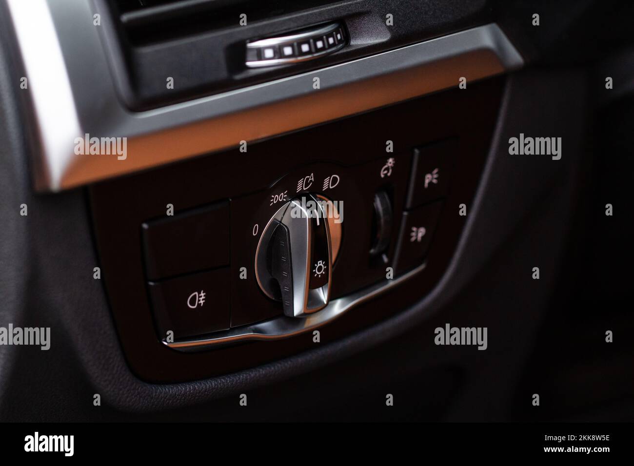 Closeup of the headlight switch control button. Lights control panel in ...
