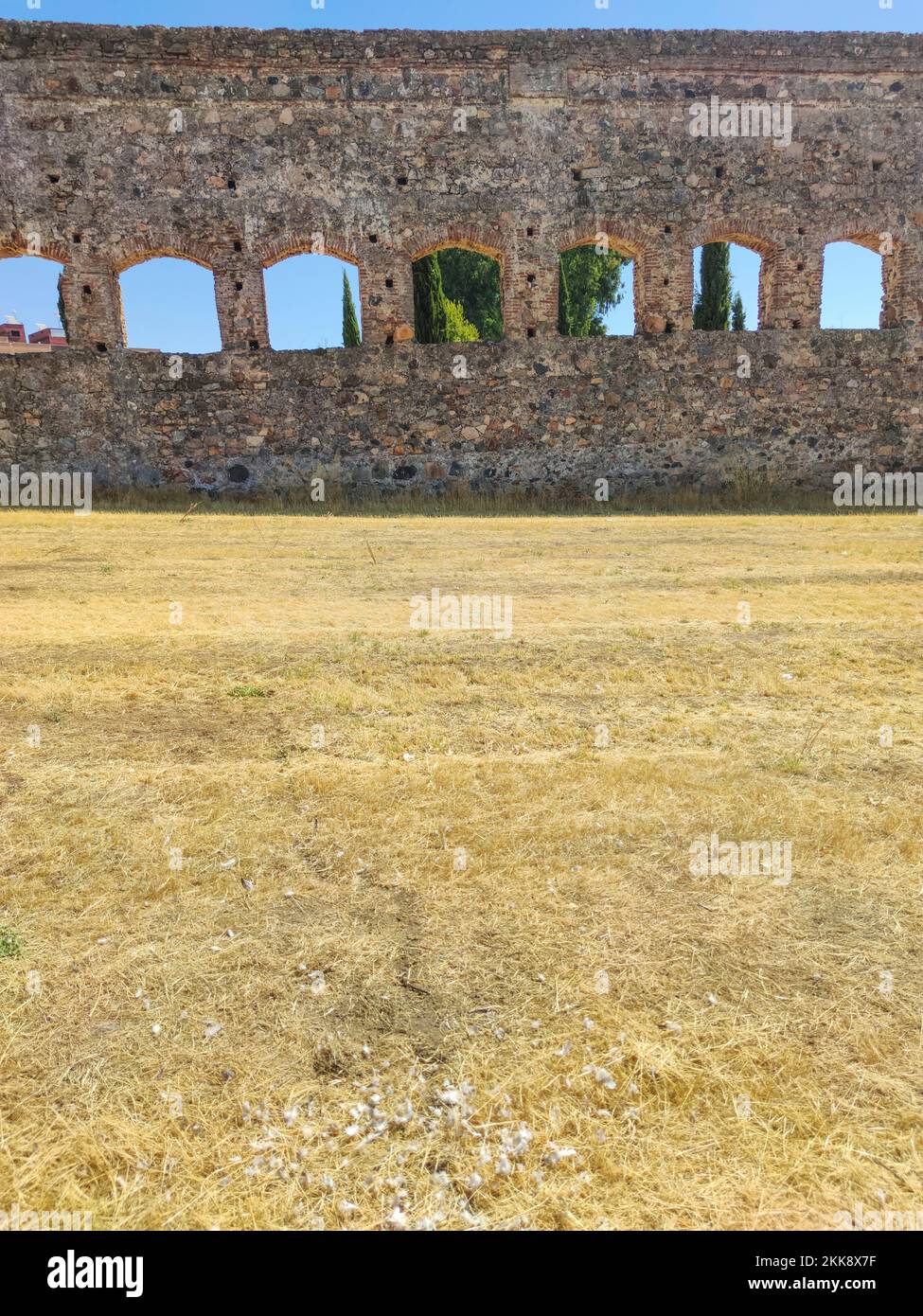 San Lazaro aqueduct over dry pasture field. Merida, Spain. Medieval ...