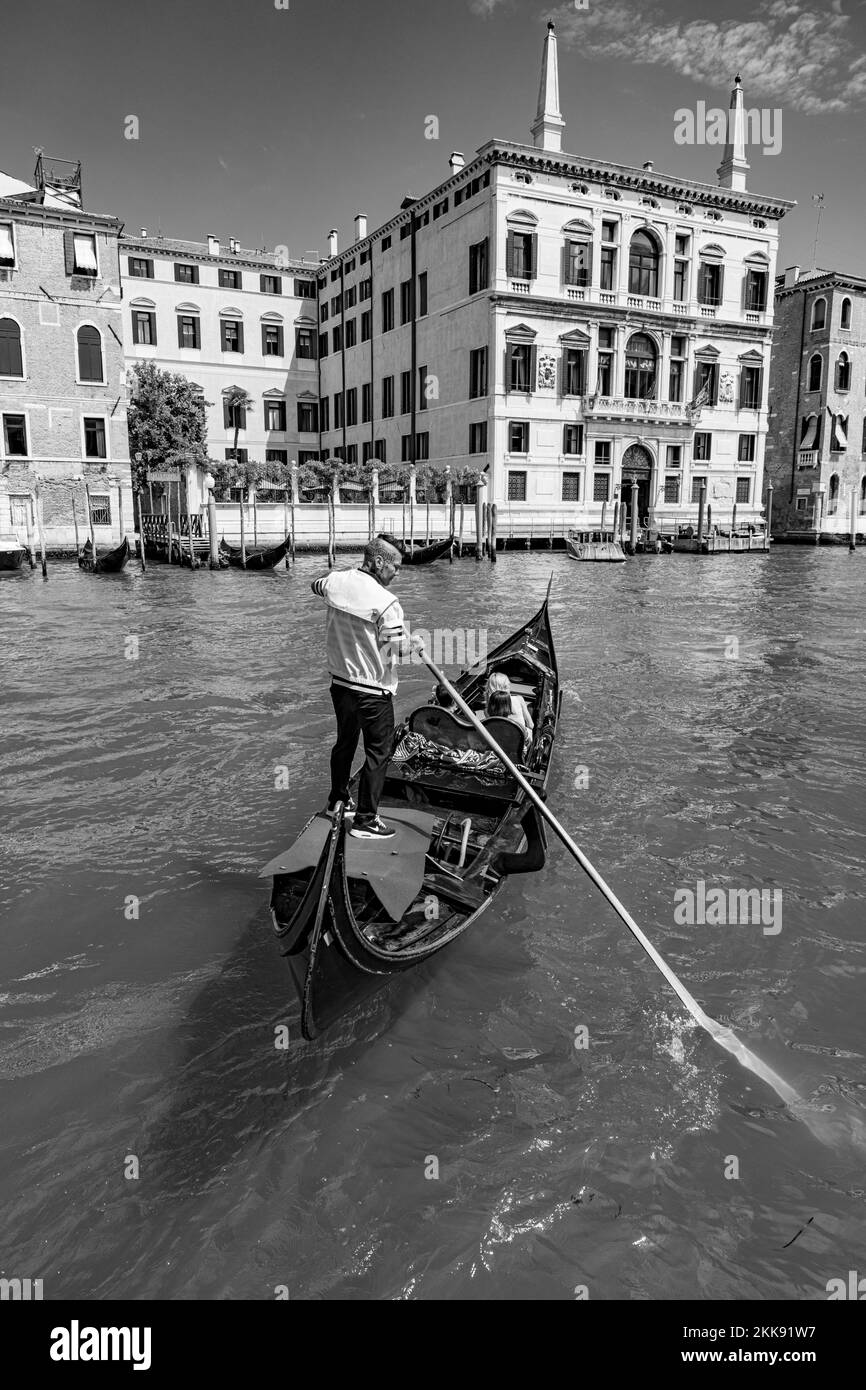 Venice, Italy - July 1, 2021: people enjoy the gondola ride at canale ...