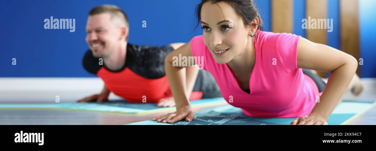 Smiling man and woman doing exercise for fit body goal, active train in ...