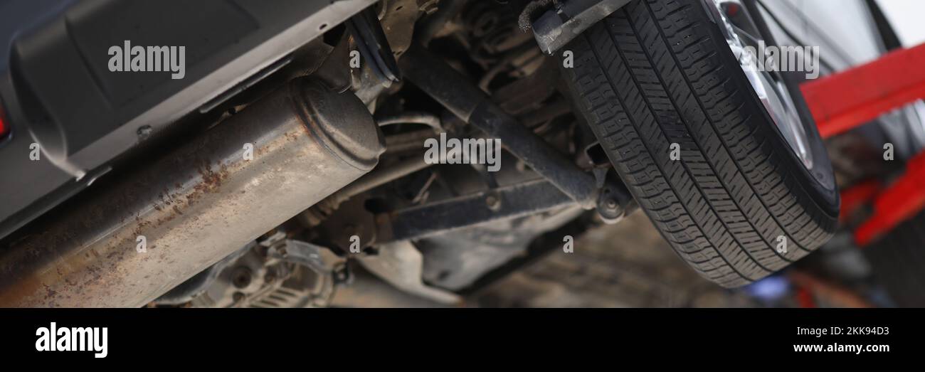 Car lifted in maintenance service for checkup, undercarriage of ...