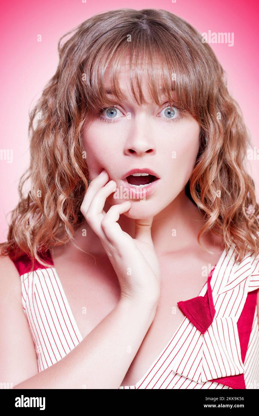 Woman looking shocked and appalled with a dropped jaw and wide eyes as ...