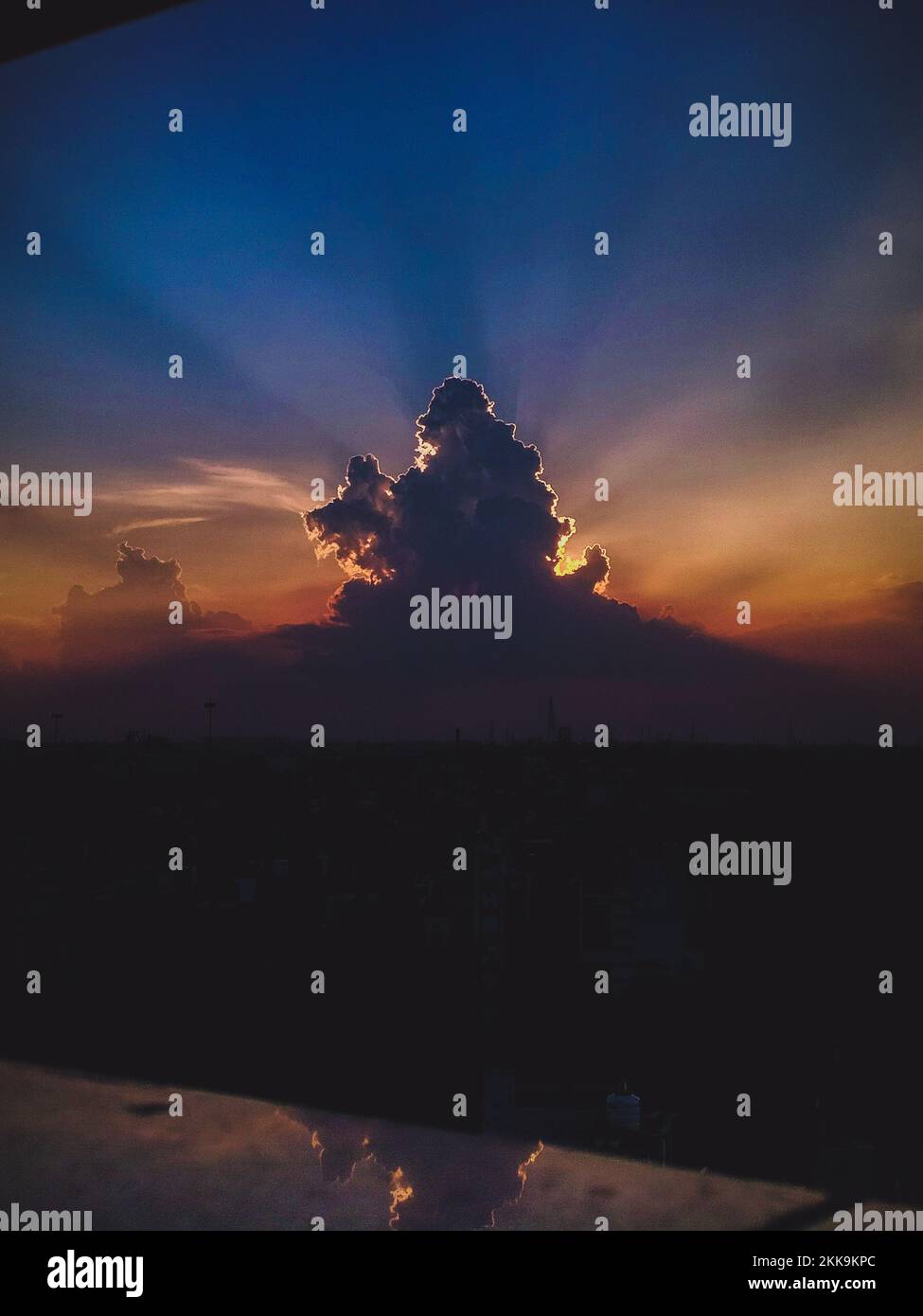 Sunset view behind clouds orange and blue tone Stock Photo - Alamy