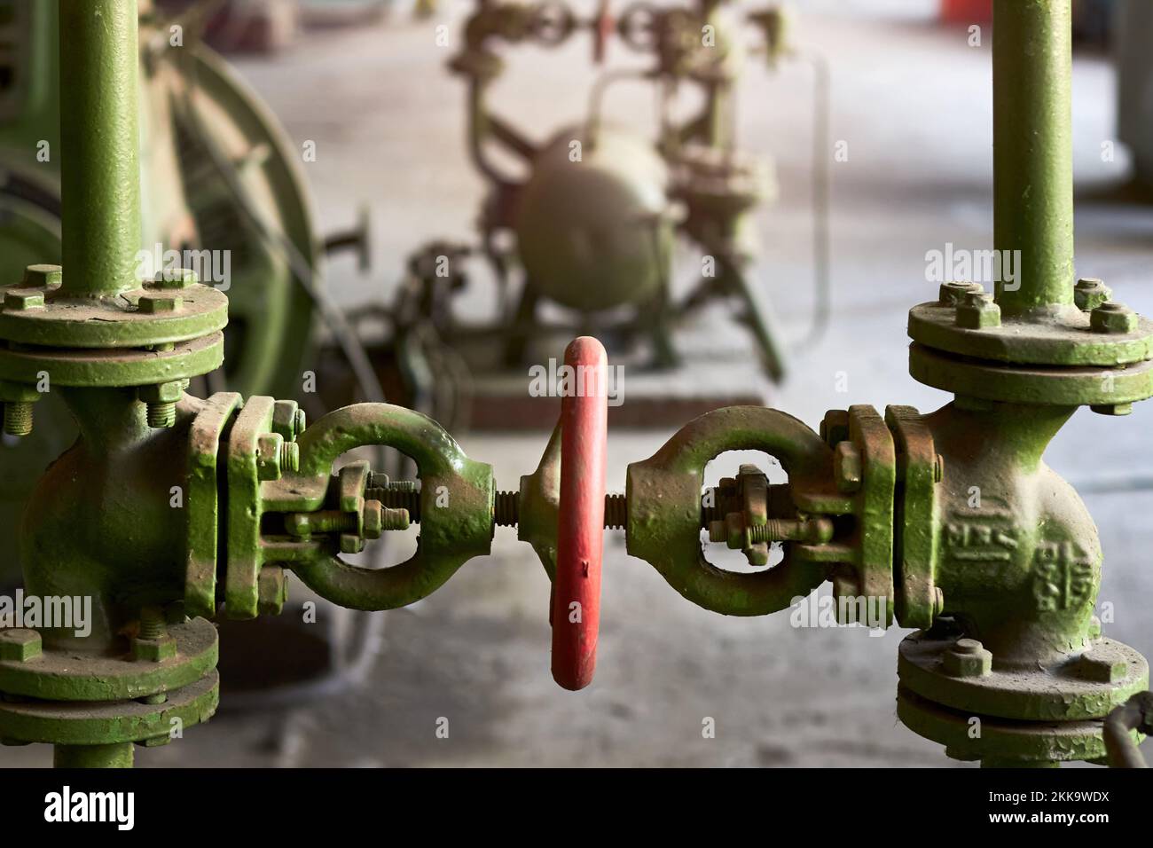 Two industrial chemical petrochemical retro style green valves closeup ...