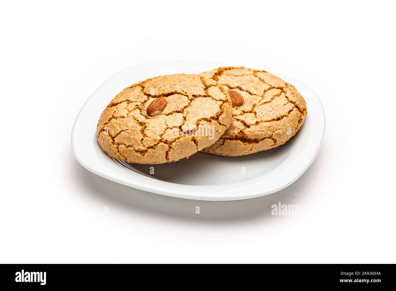 The delicious round almond cookies on white plate isolated on white ...