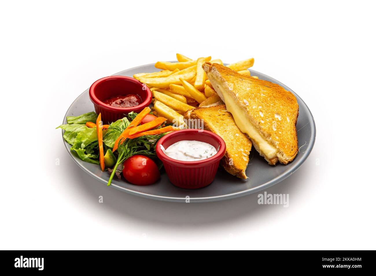 A dinner plate with french toast, fries, sauces and vegetable salad ...